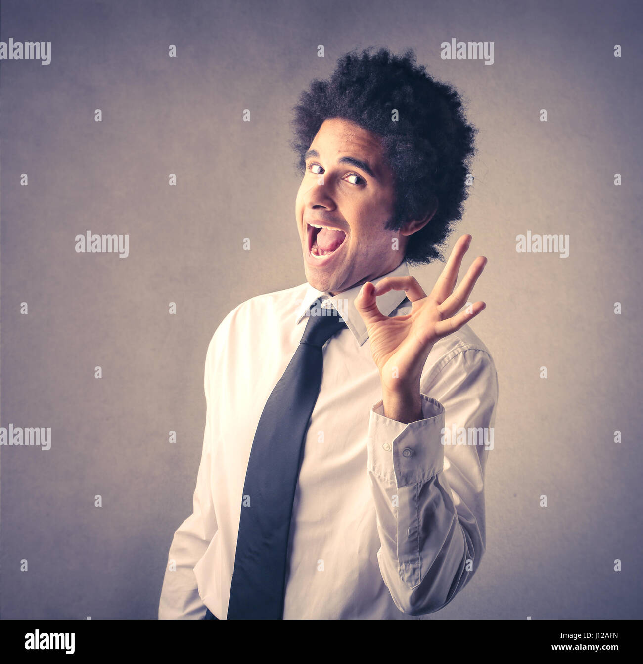 Businessman showing perfect sign Stock Photo - Alamy