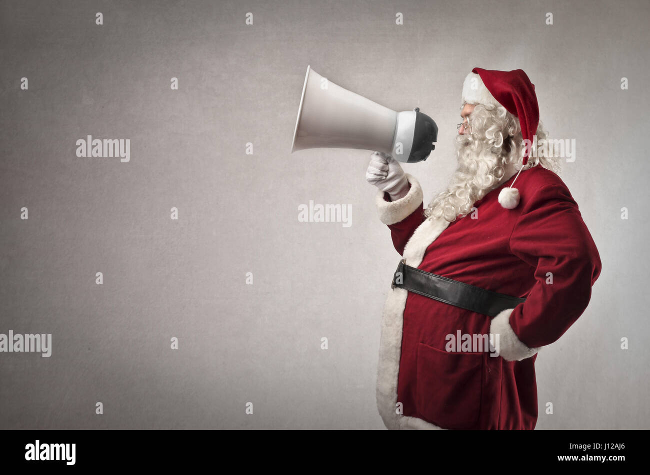 Santa Claus holding megaphone Stock Photo - Alamy