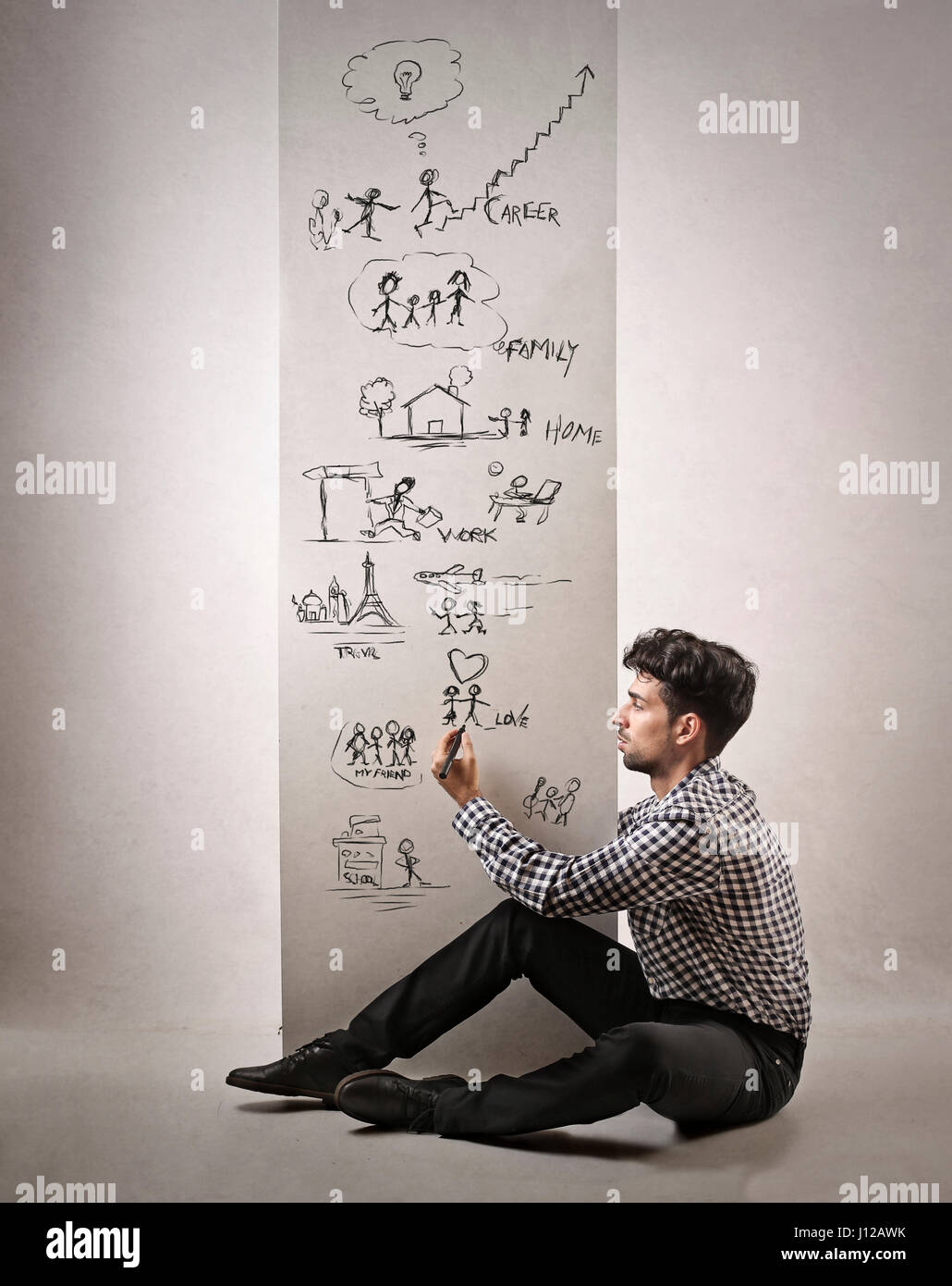 Man drawing his life on wall Stock Photo - Alamy