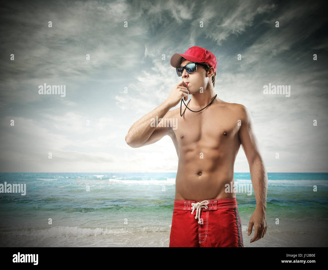 Life guard man on the beach with whistle Stock Photo - Alamy