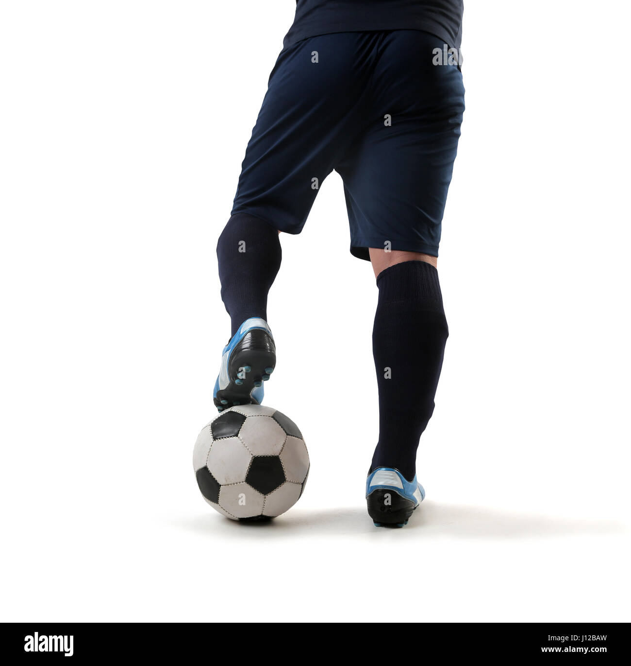 Man standing on soccer ball Stock Photo - Alamy