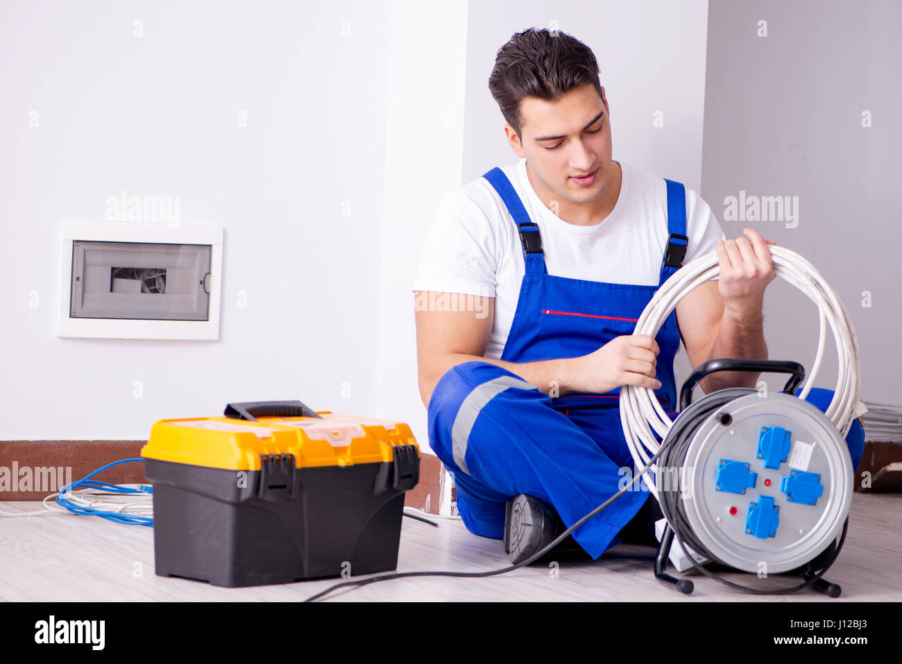Man doing electrical repairs at home Stock Photo - Alamy