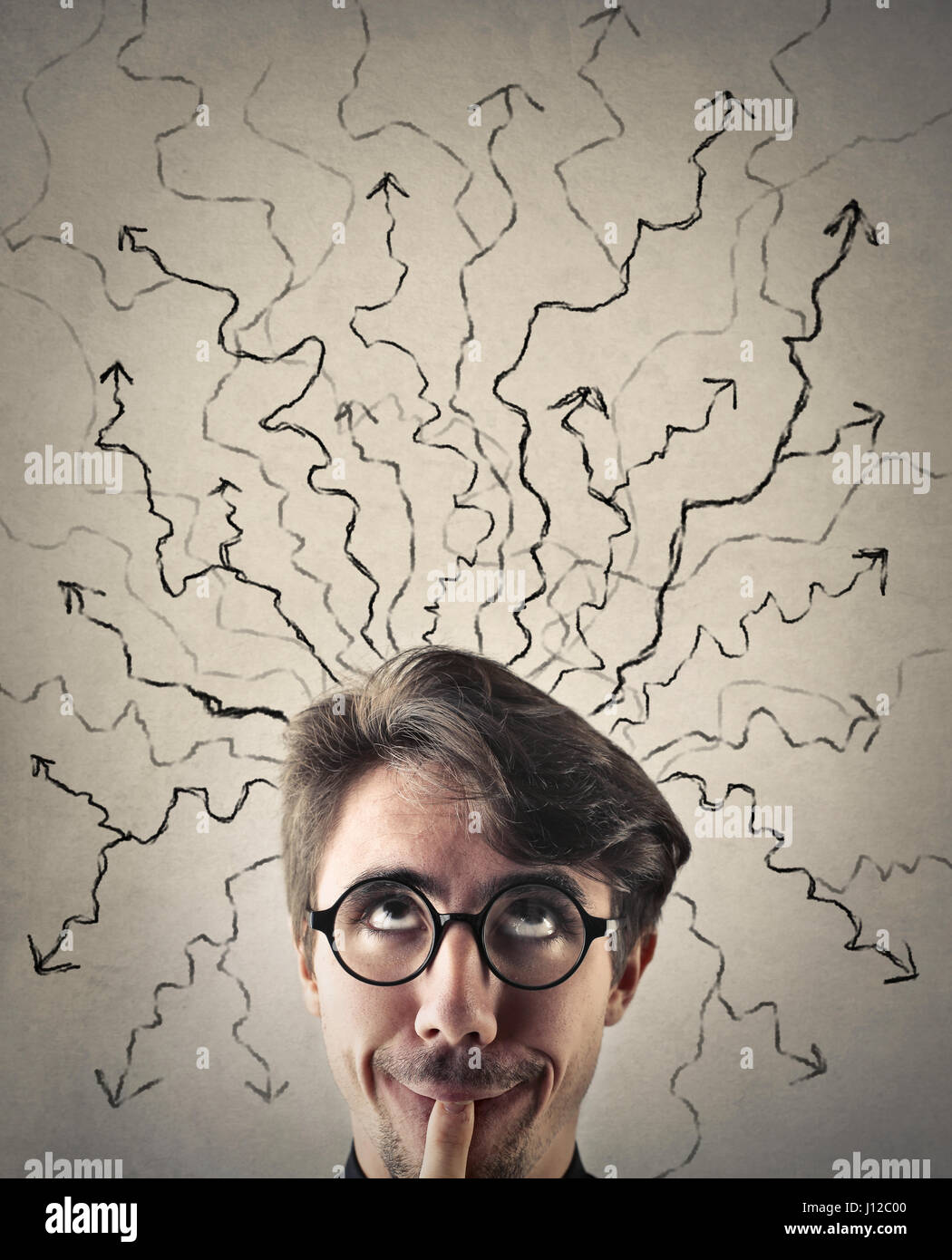 Businessman with arrows coming out of his head Stock Photo - Alamy