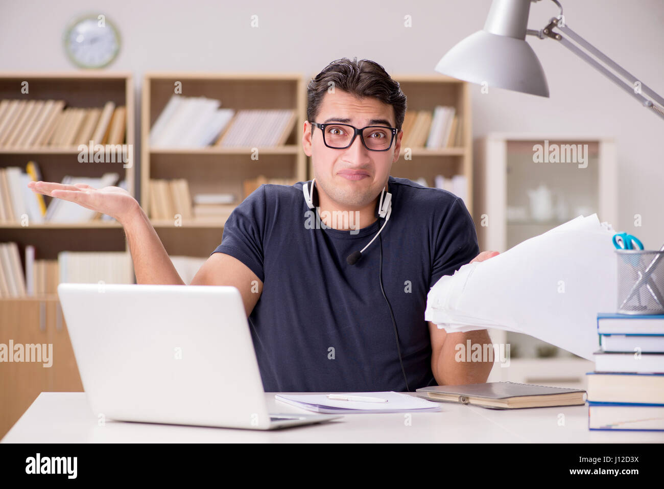 Angry man with too much paperwork to do Stock Photo - Alamy