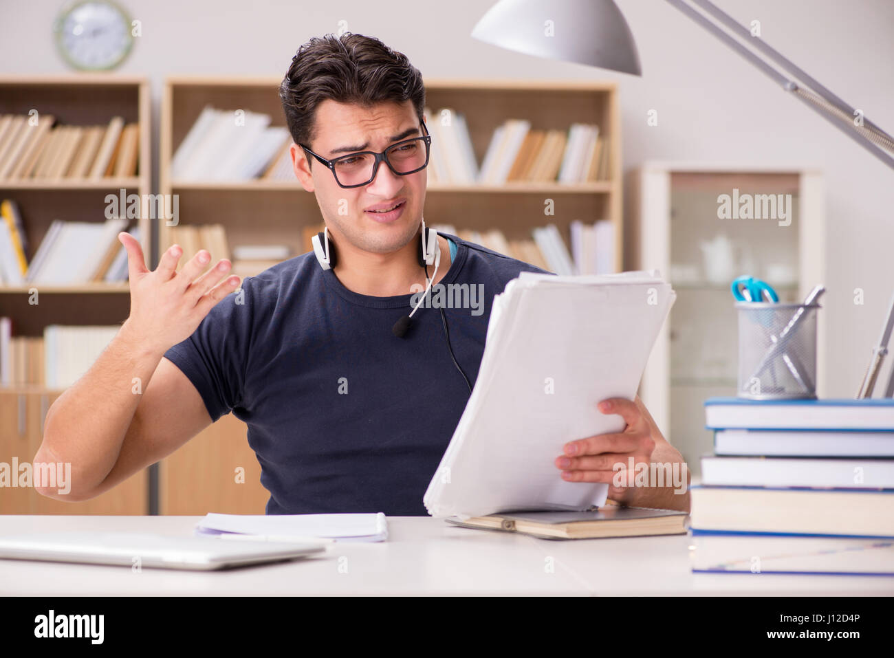 Unhappy student with too much to study Stock Photo - Alamy