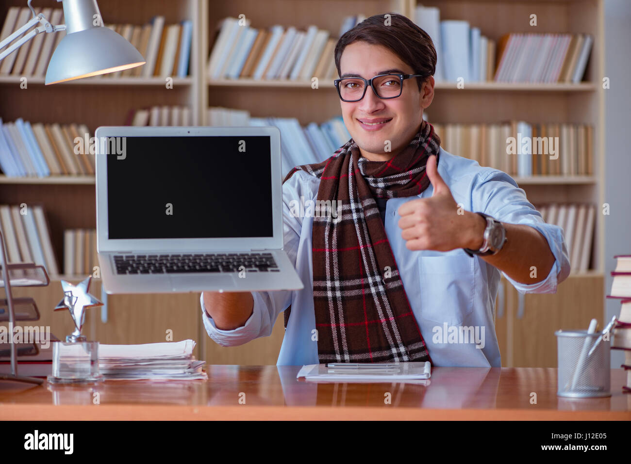 Young book writer writing in library Stock Photo - Alamy