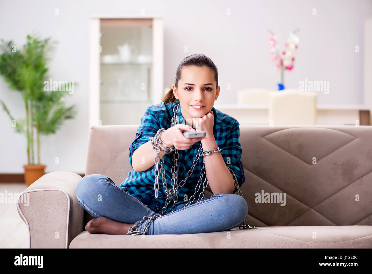 Young girl addicted to tv wasting her time Stock Photo - Alamy