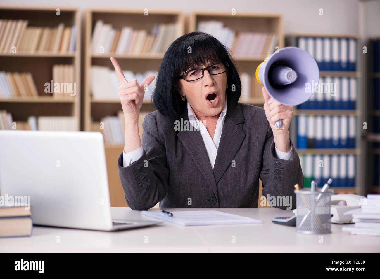 Angry businesswoman shouting with loudspeaker Stock Photo - Alamy