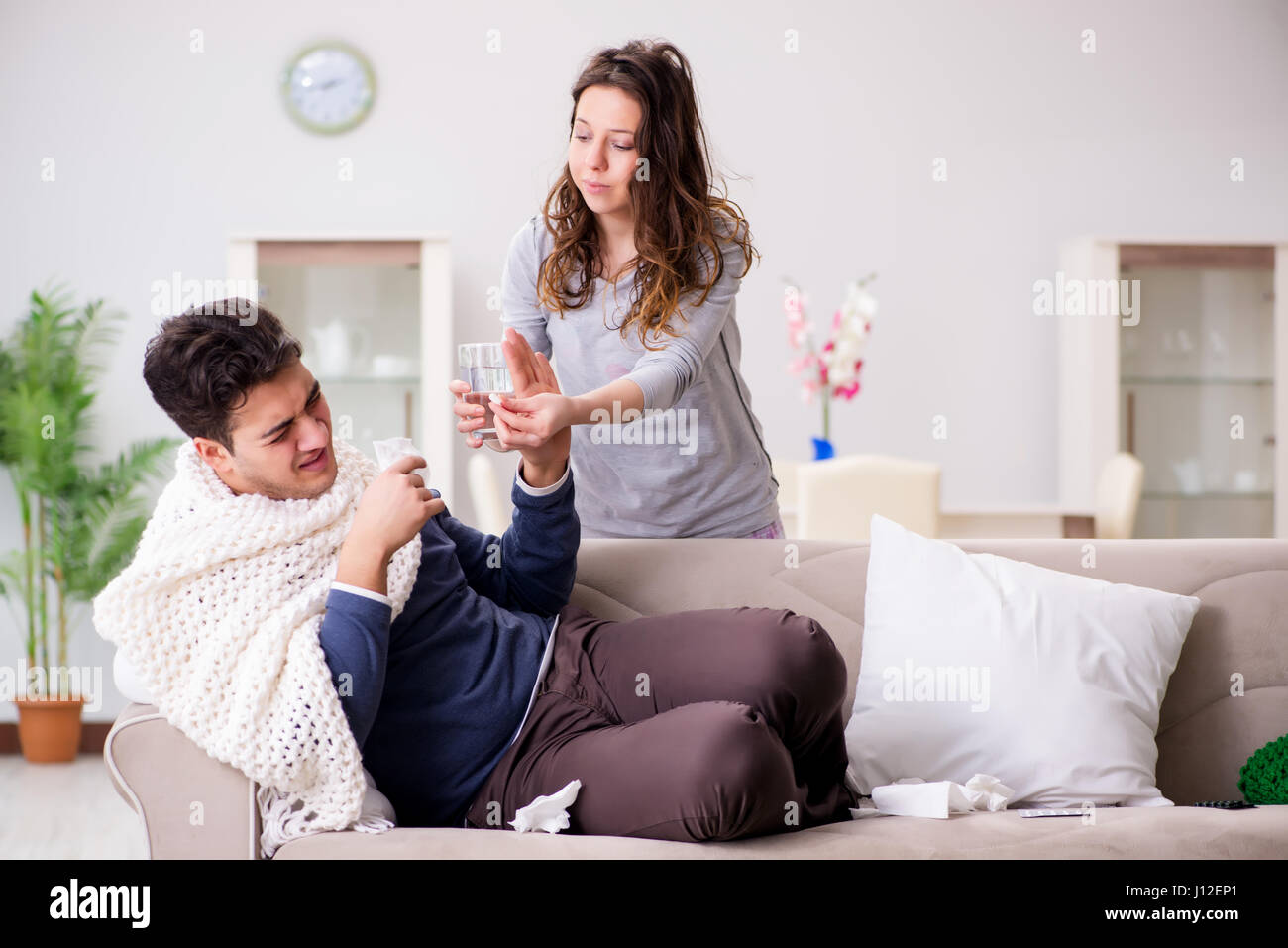 Wife caring for sick husband at home Stock Photo - Alamy