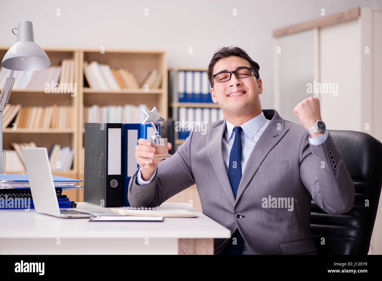 Businessman receiving award in the office Stock Photo - Alamy