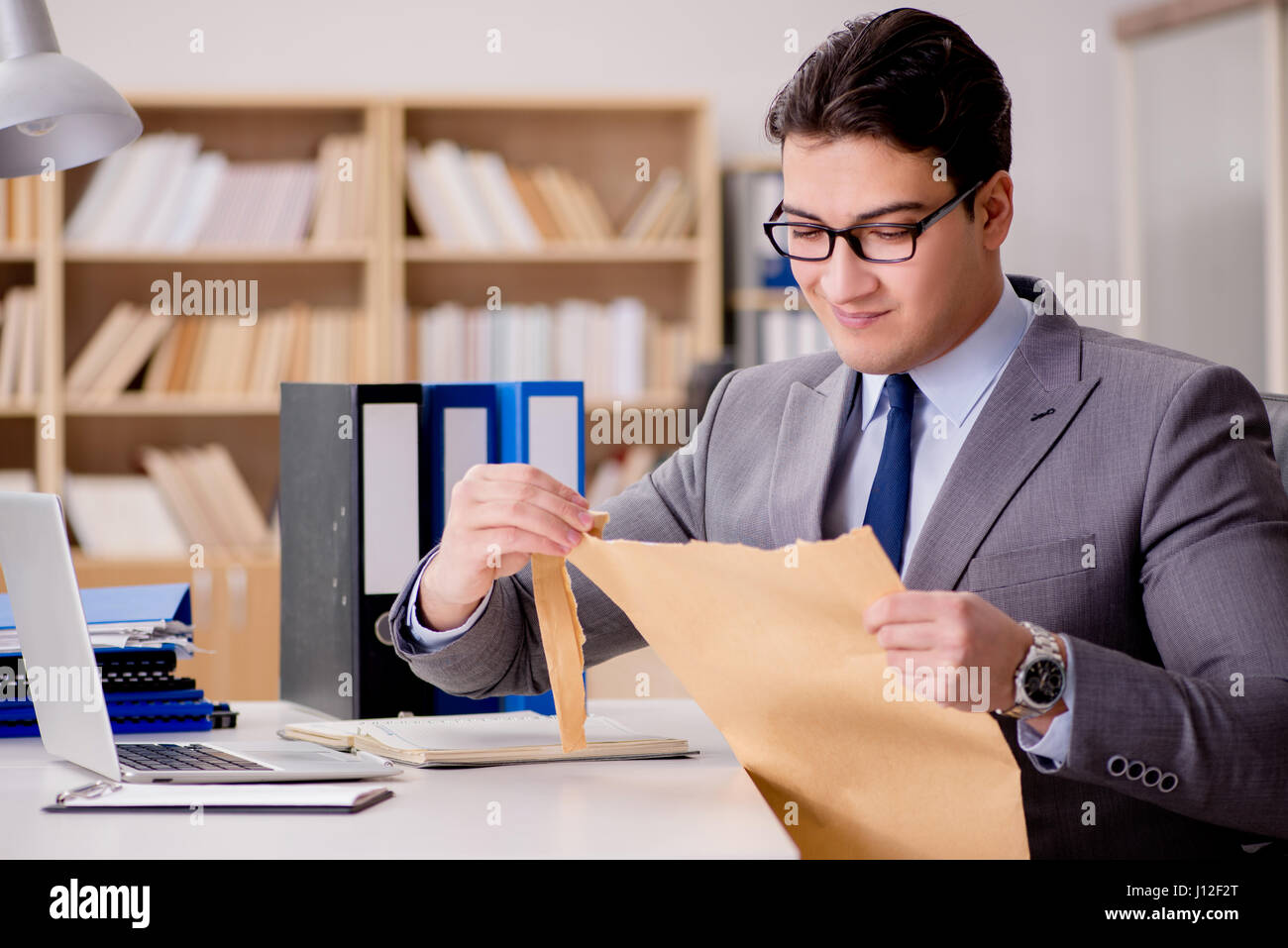Businessman receiving letter envelope in office Stock Photo - Alamy