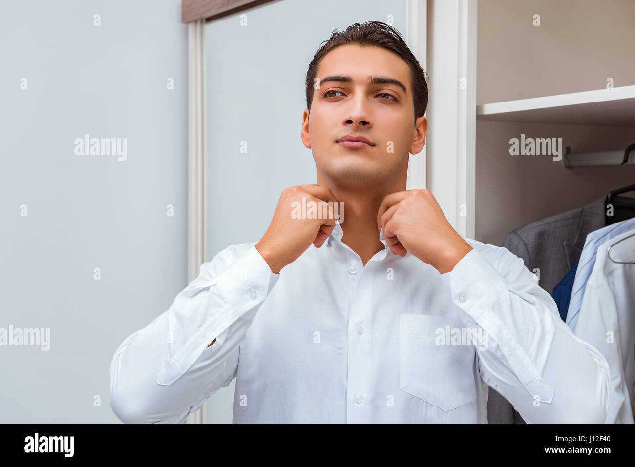 Businessman dressing up for work Stock Photo - Alamy