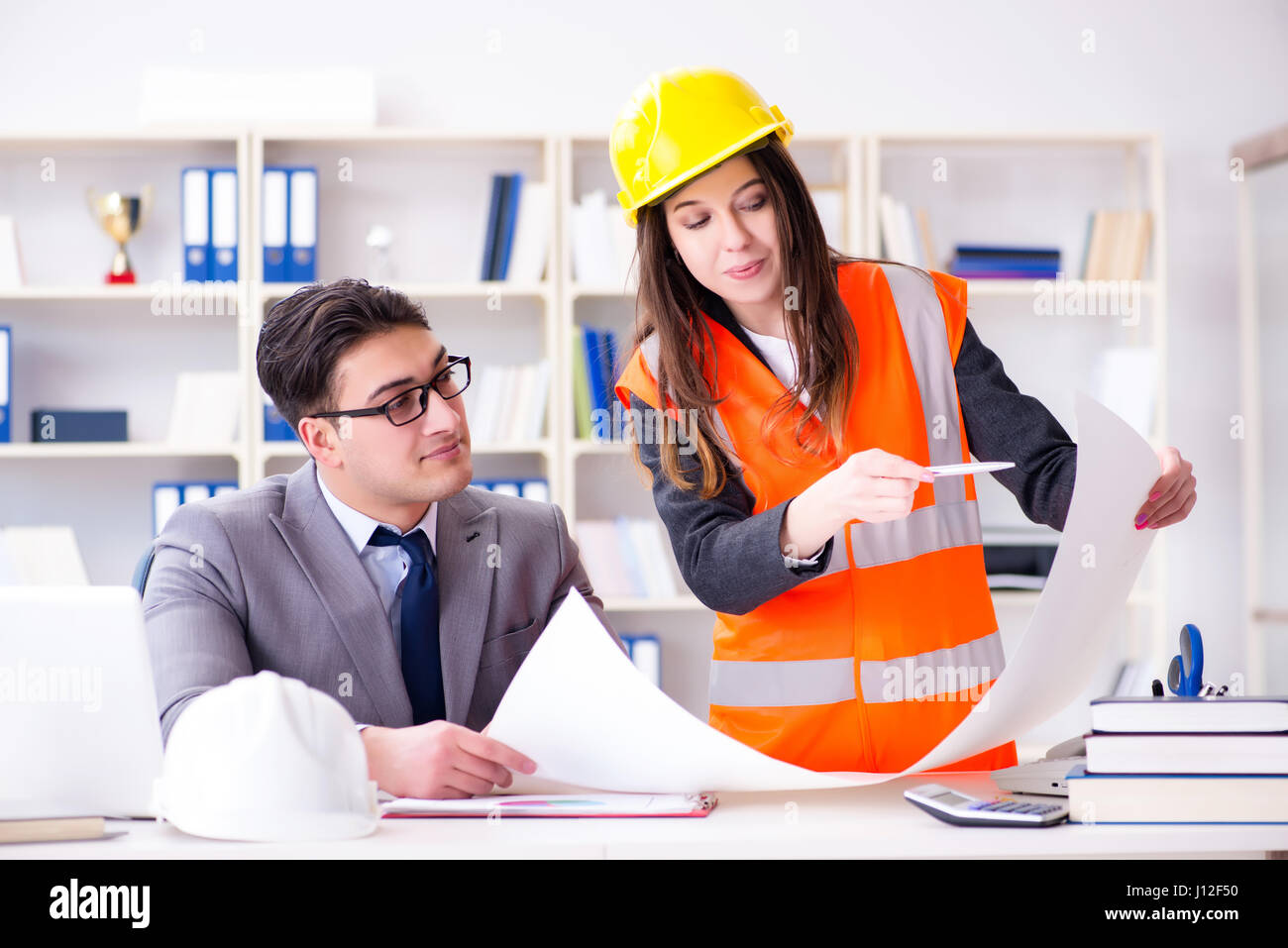 Construction foreman supervisor reviewing drawings Stock Photo - Alamy