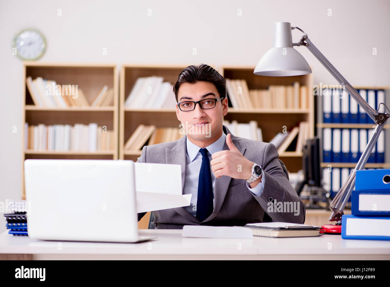 Businessman receiving letter envelope in office Stock Photo - Alamy