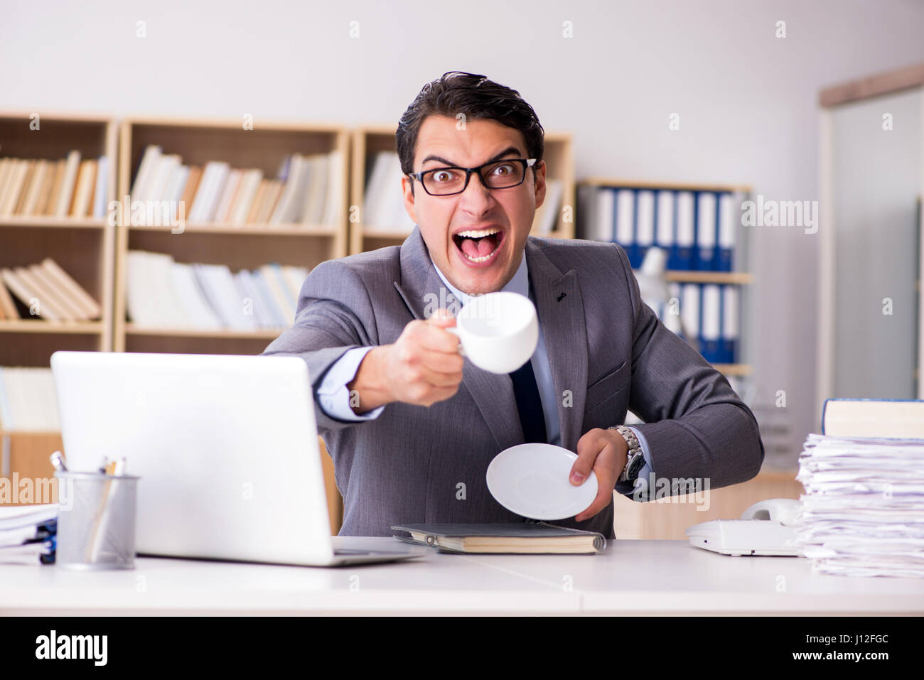 Angry businessman working in the office Stock Photo - Alamy