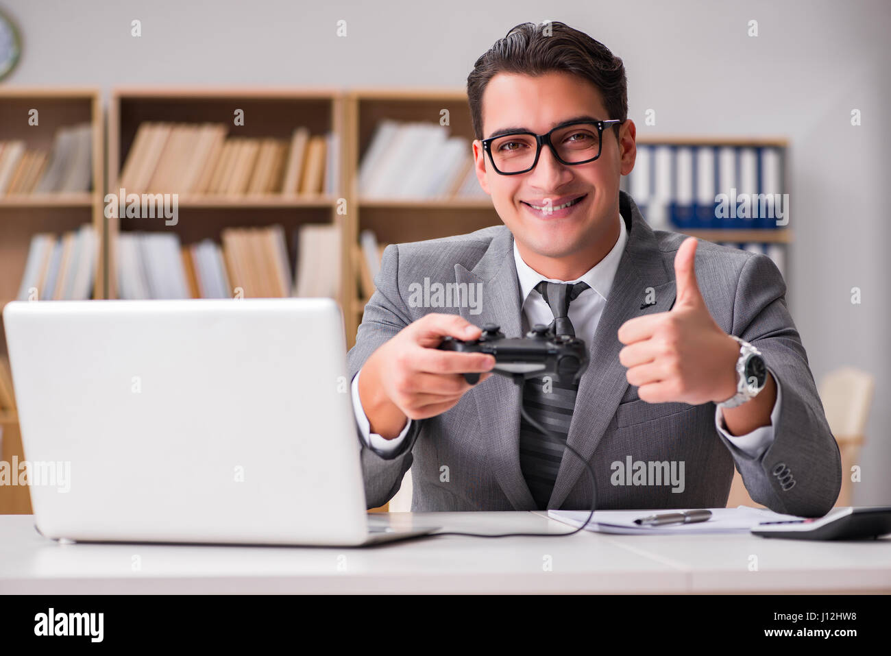 Businessman playing computer games at work office Stock Photo - Alamy