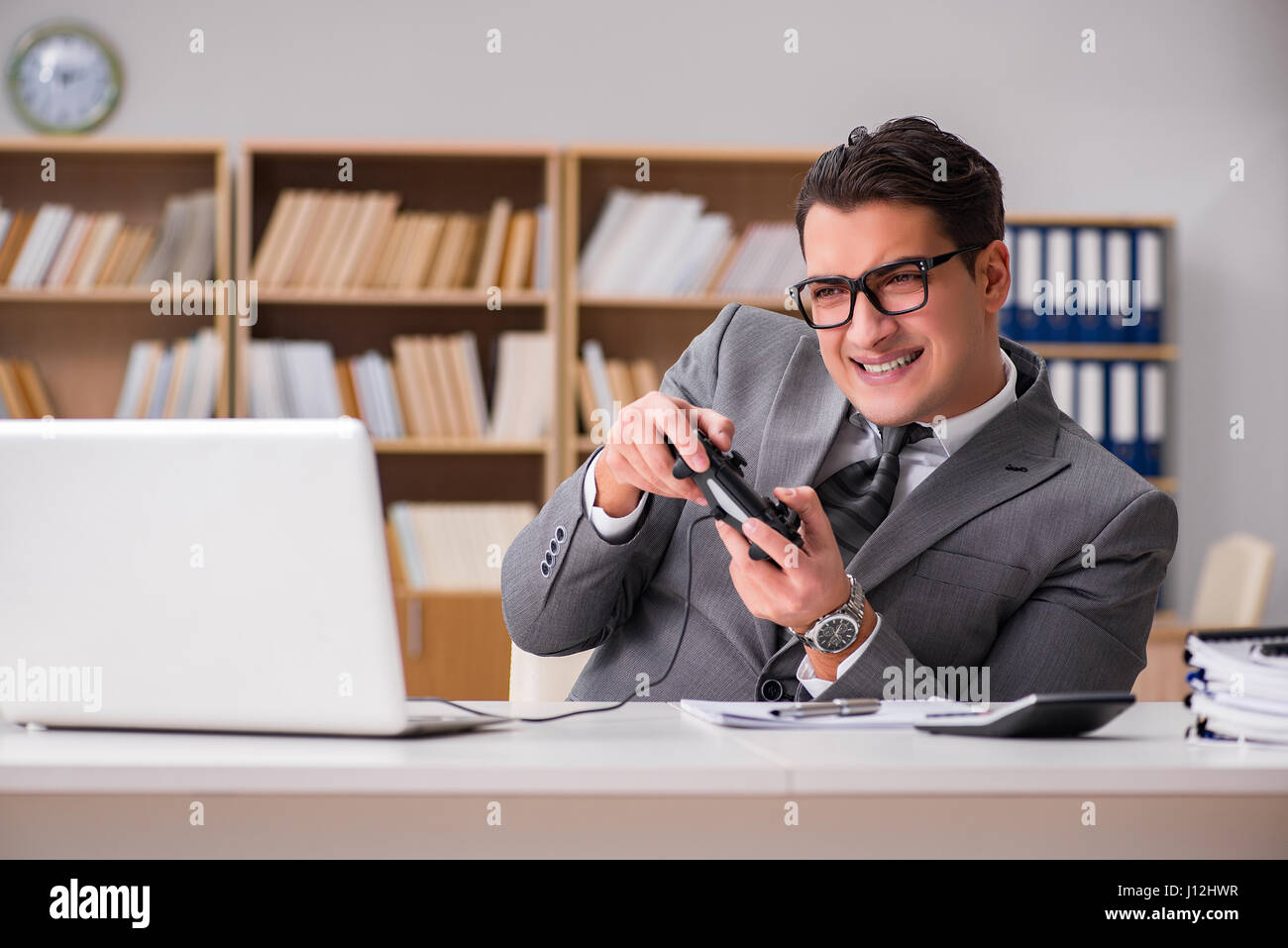 Businessman playing computer games at work office Stock Photo - Alamy