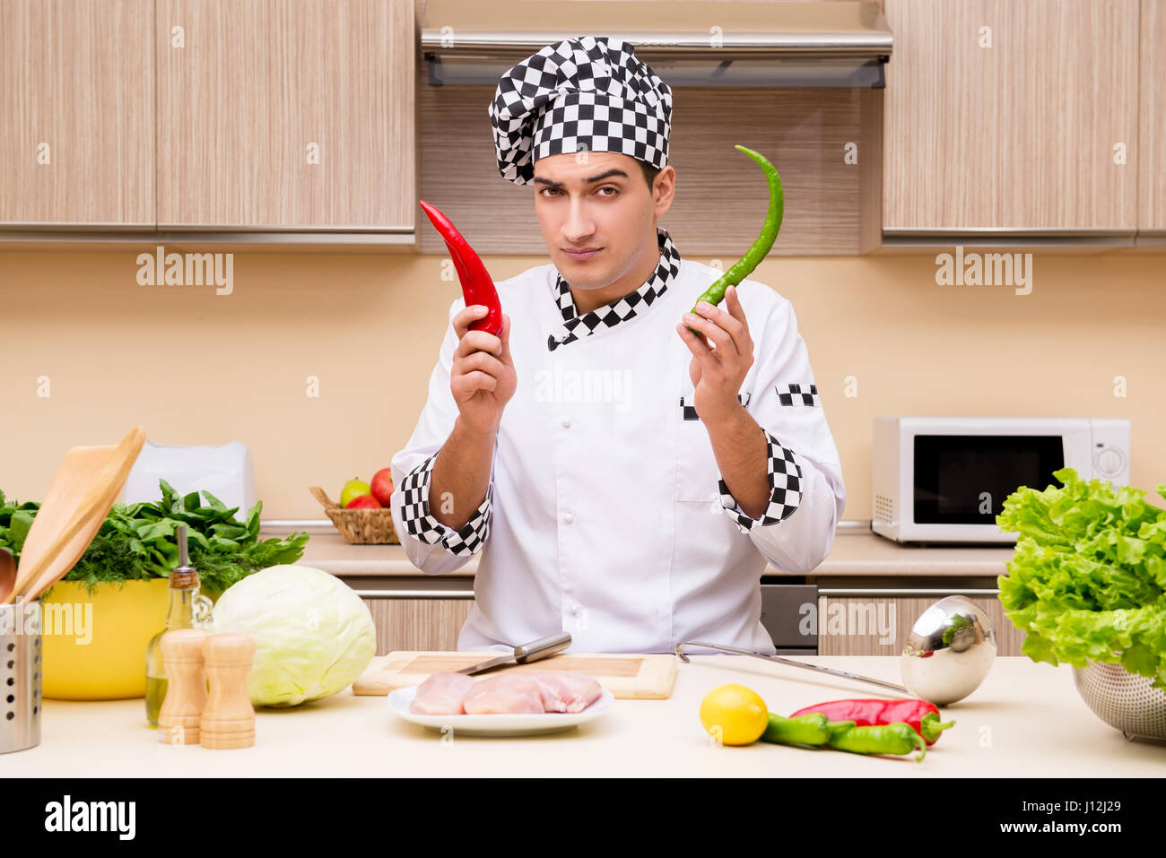 Young chef working in the kitchen Stock Photo - Alamy