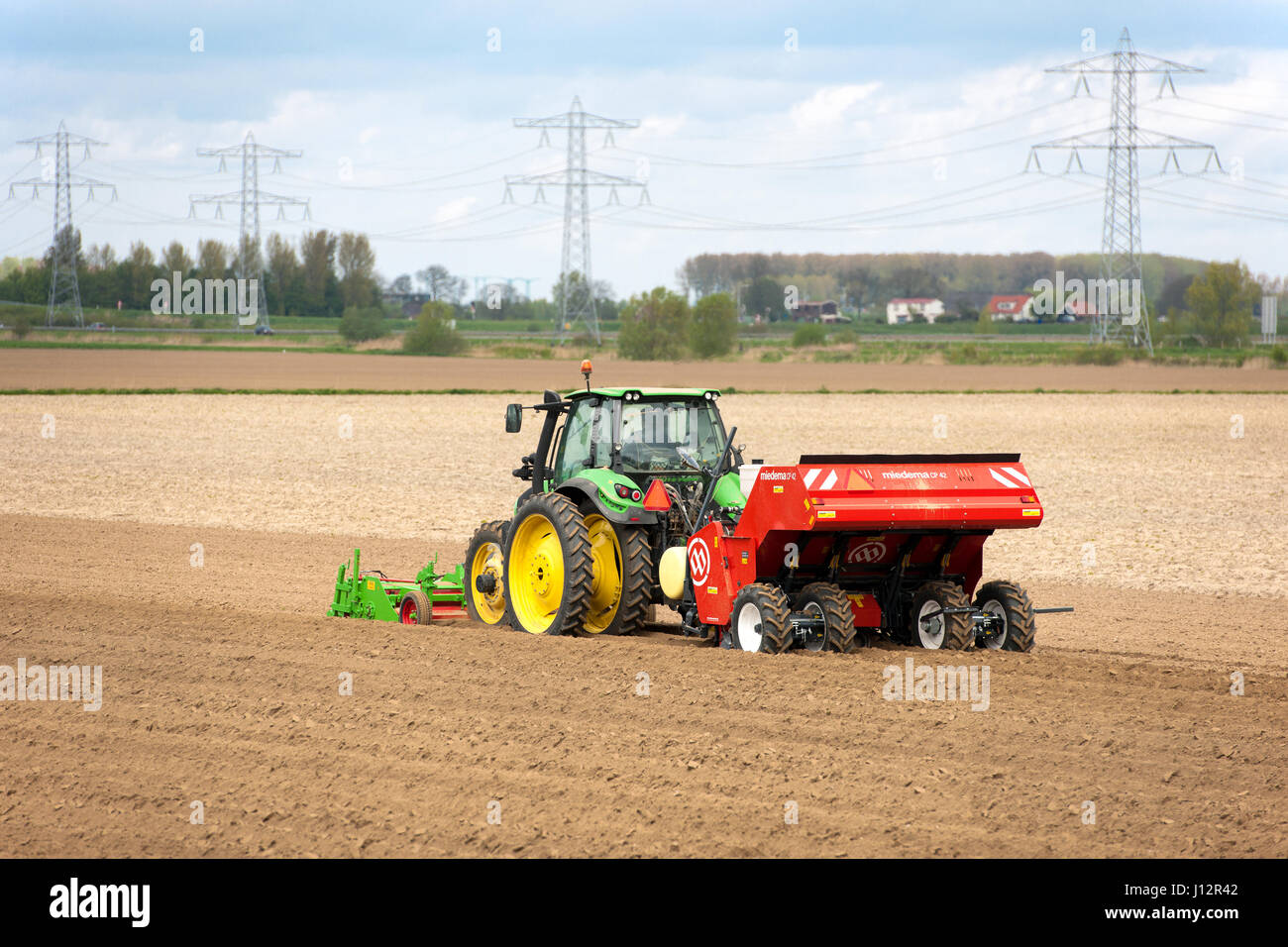Farmers with agricultural vehicles are busy sowing their fields in the ...