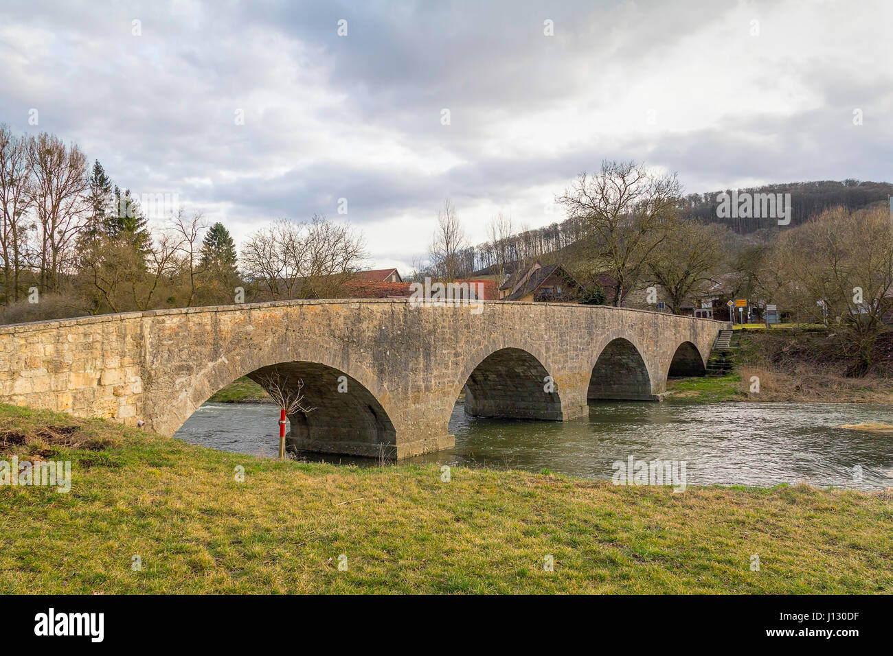historic stone bridge at a small rural village named Oberregenbach near ...