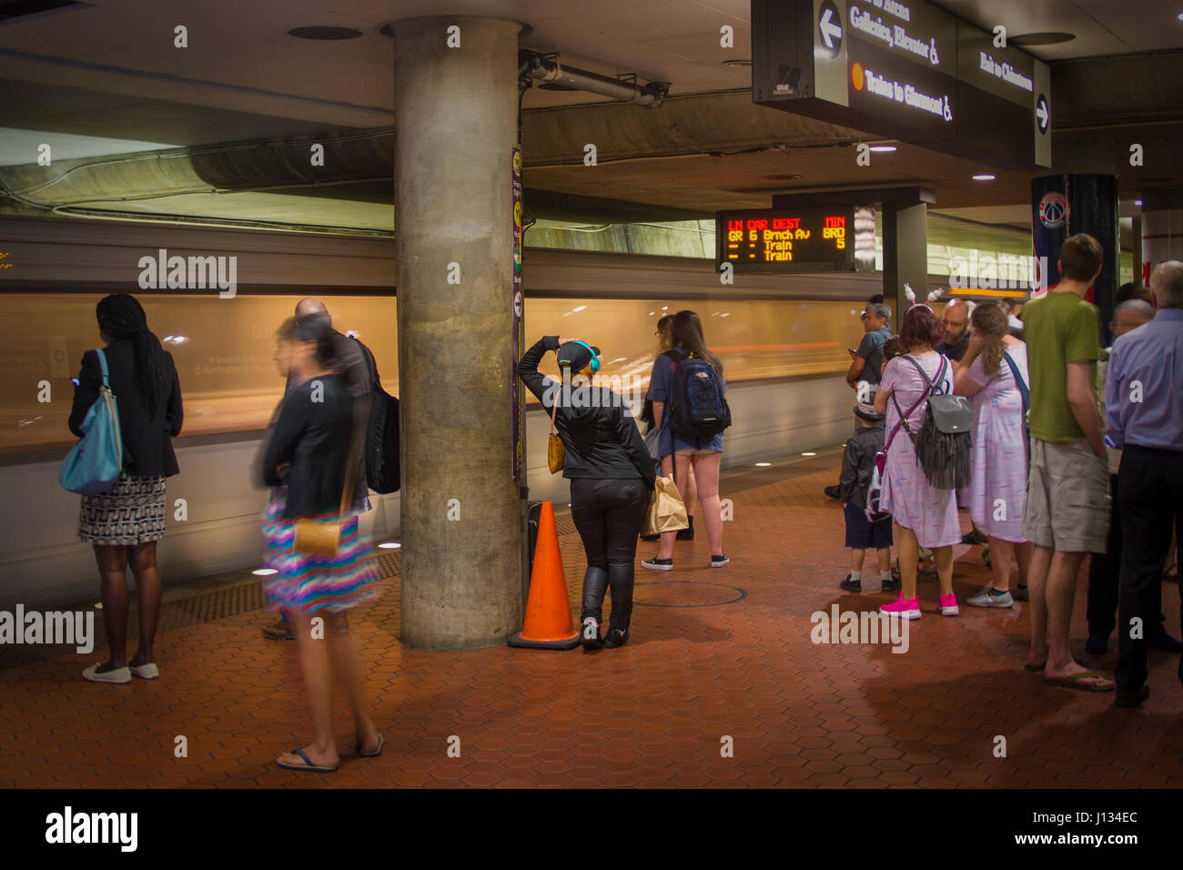 Passengers wait to board a Metro train on the lower level platform of ...