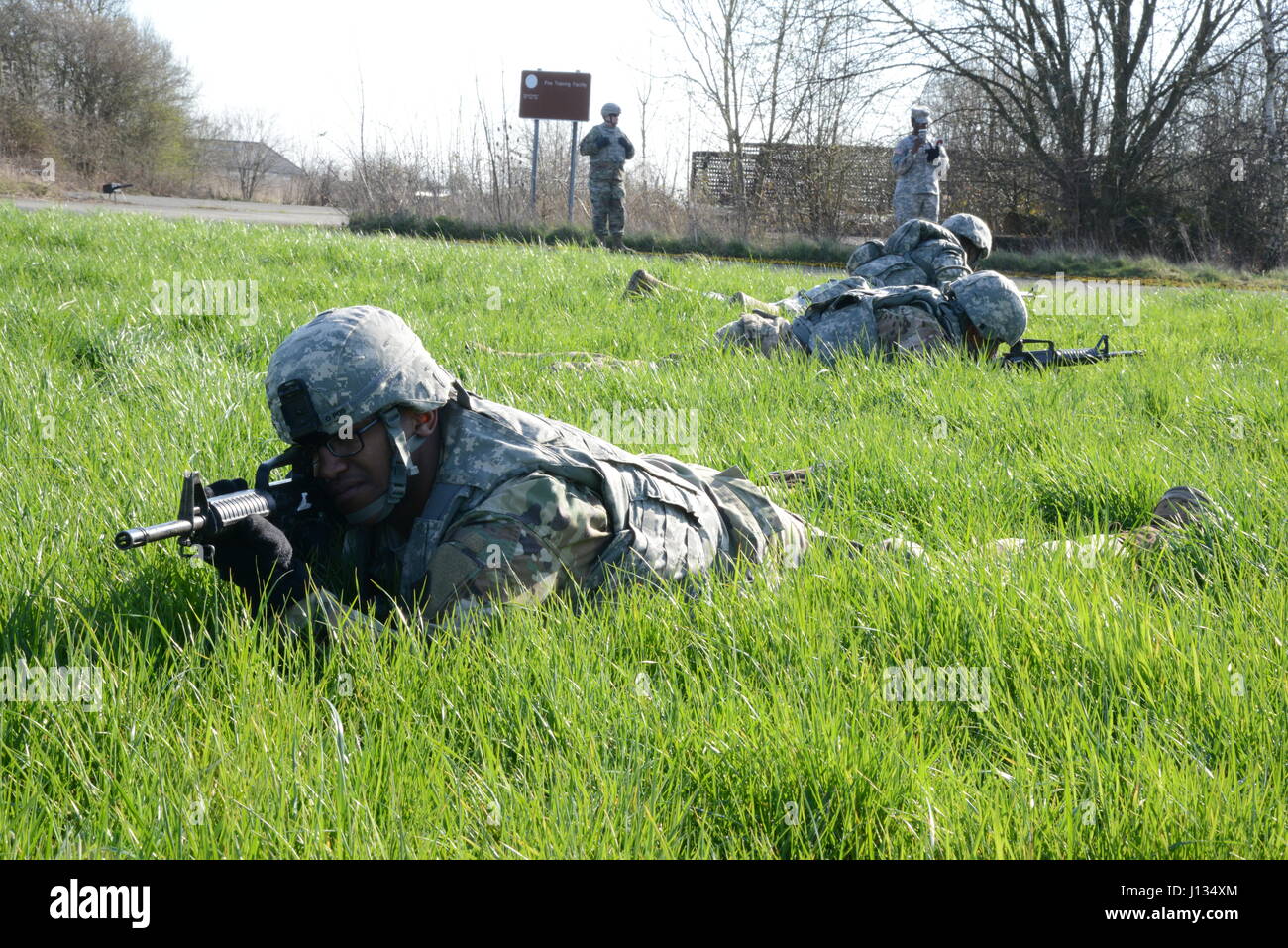 U.S. Soldiers, assigned to 39th Signal Battalion, take a prone position ...