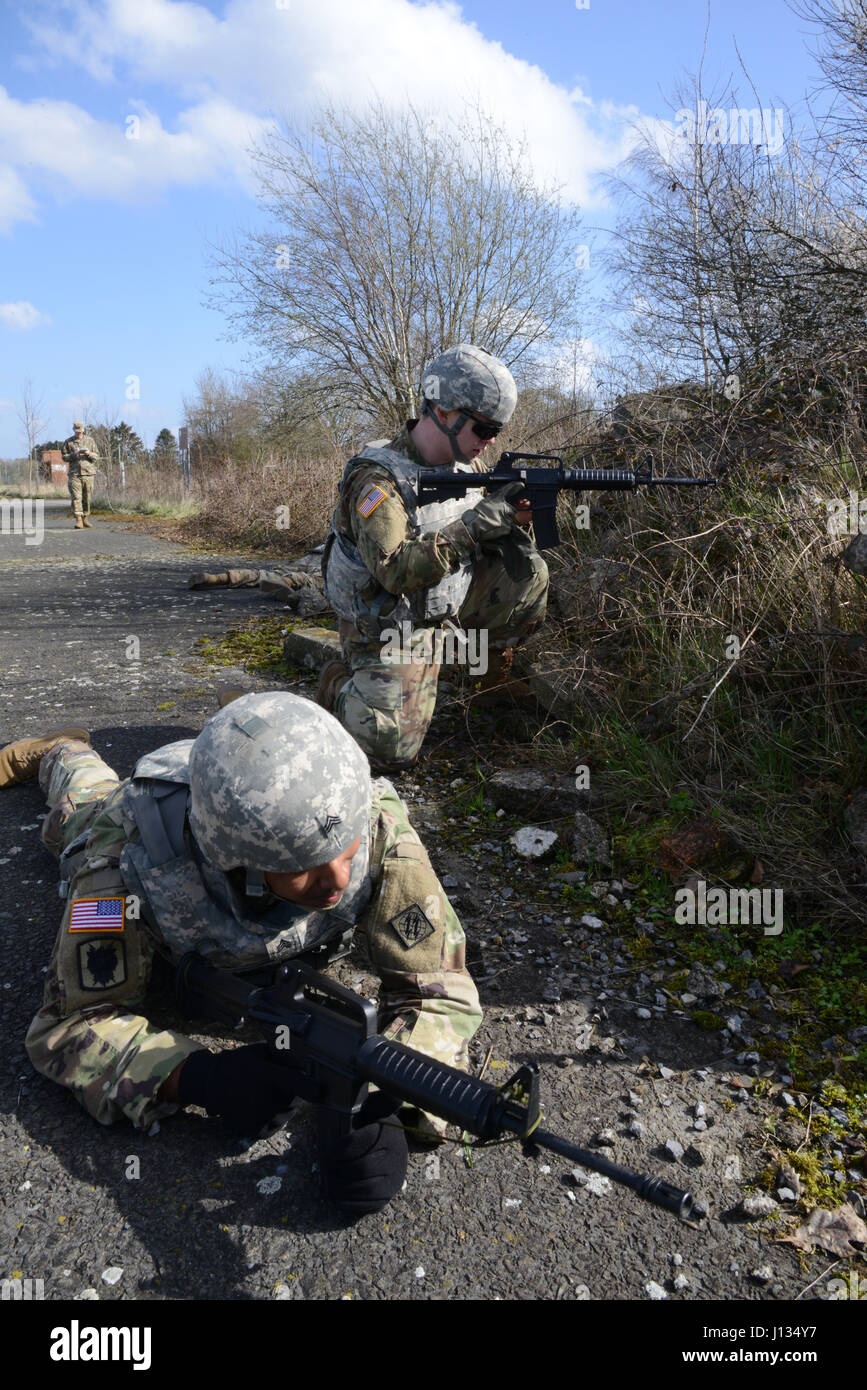 U.S. Army Pfc.Trevor Lamere protected by Sgt. Joel Delerosa, both ...
