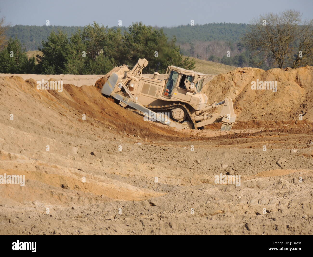A British engineer trains on a U.S. Army D7R bulldozer during a ...