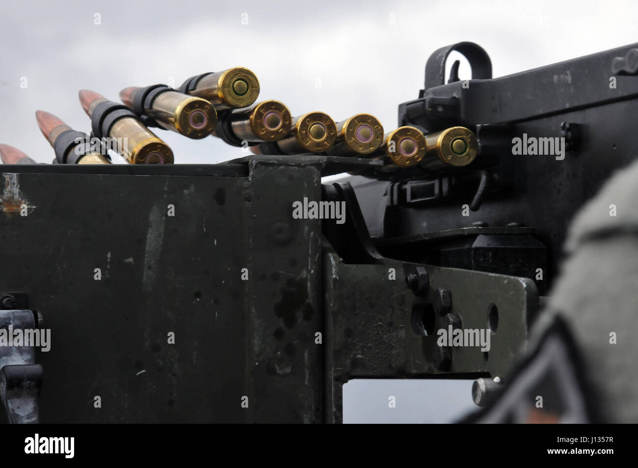 Rounds from a M2 50-caliber machine gun bounce as they are fed into the ...