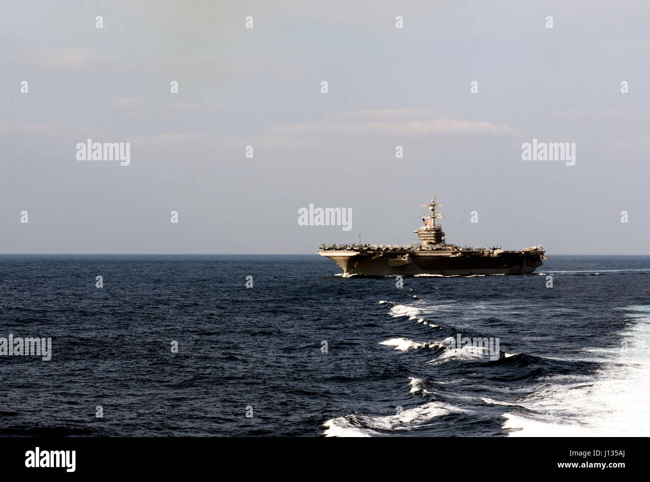 USS Carl Vinson, a Nimitz-class aircraft carrier, transits the ...