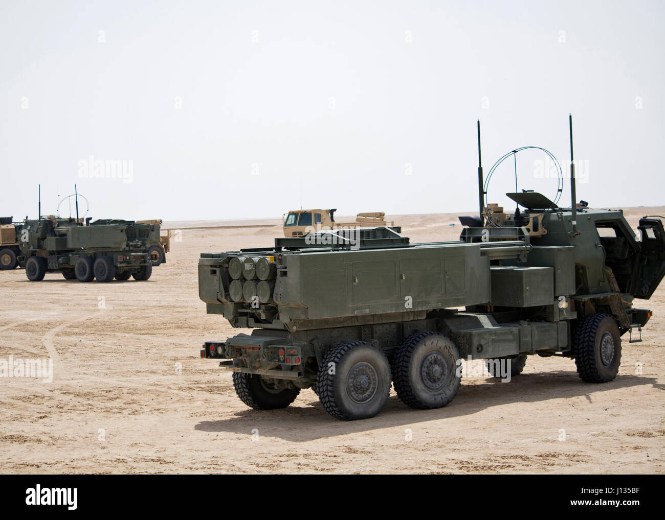 Two High Mobility Artillery Rocket System weapons systems (green), with ...