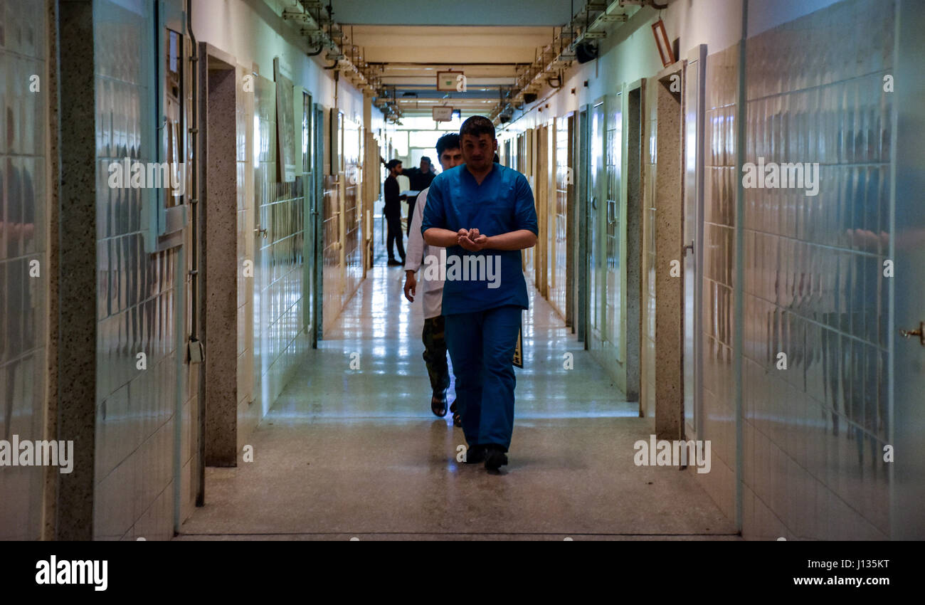 A Kabul National Military Hospital staff member conducts medical rounds ...