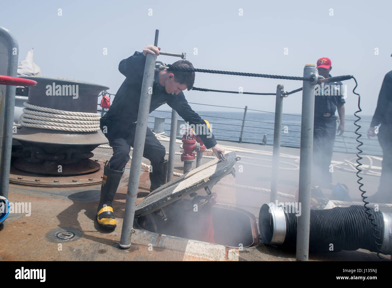 A U.S. Navy Hull Maintenance Technician ventilates the boatswain's ...