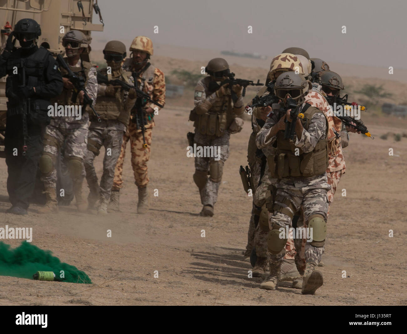 A team of multinational special operations forces approaches a pair of ...