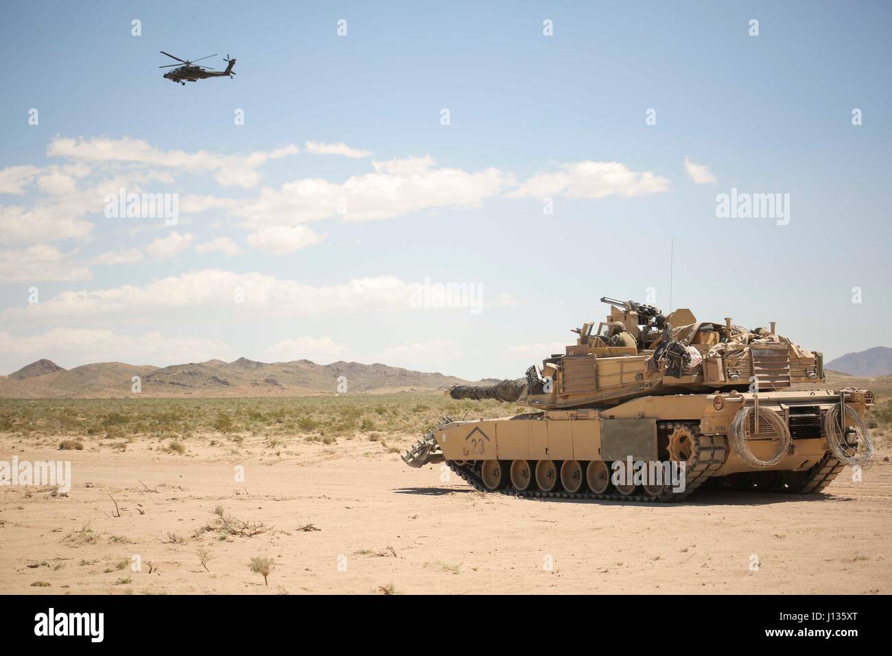 U.S. Soldiers in an AH-64 Apache Attack Helicopter, assigned to the 1st ...