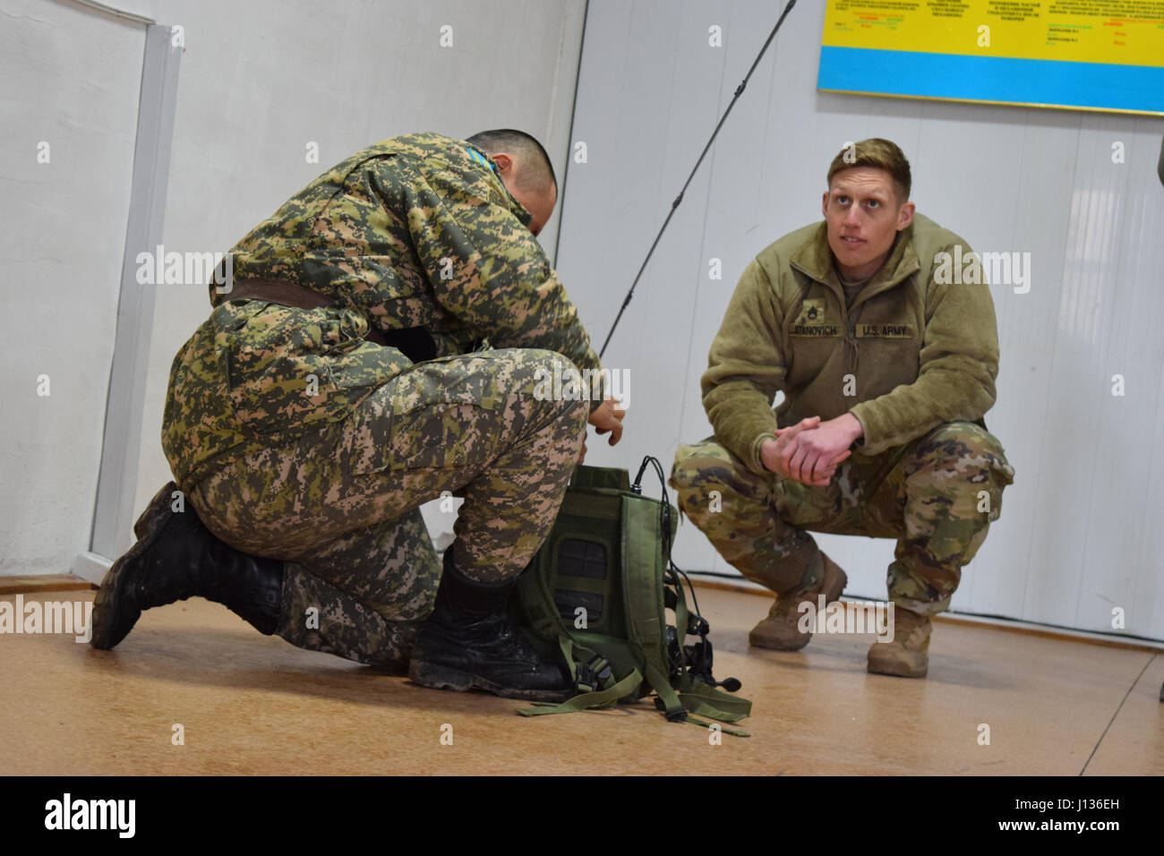 Staff Sgt. Joshua Atanovich, 149th Military Engagement Team, watches ...
