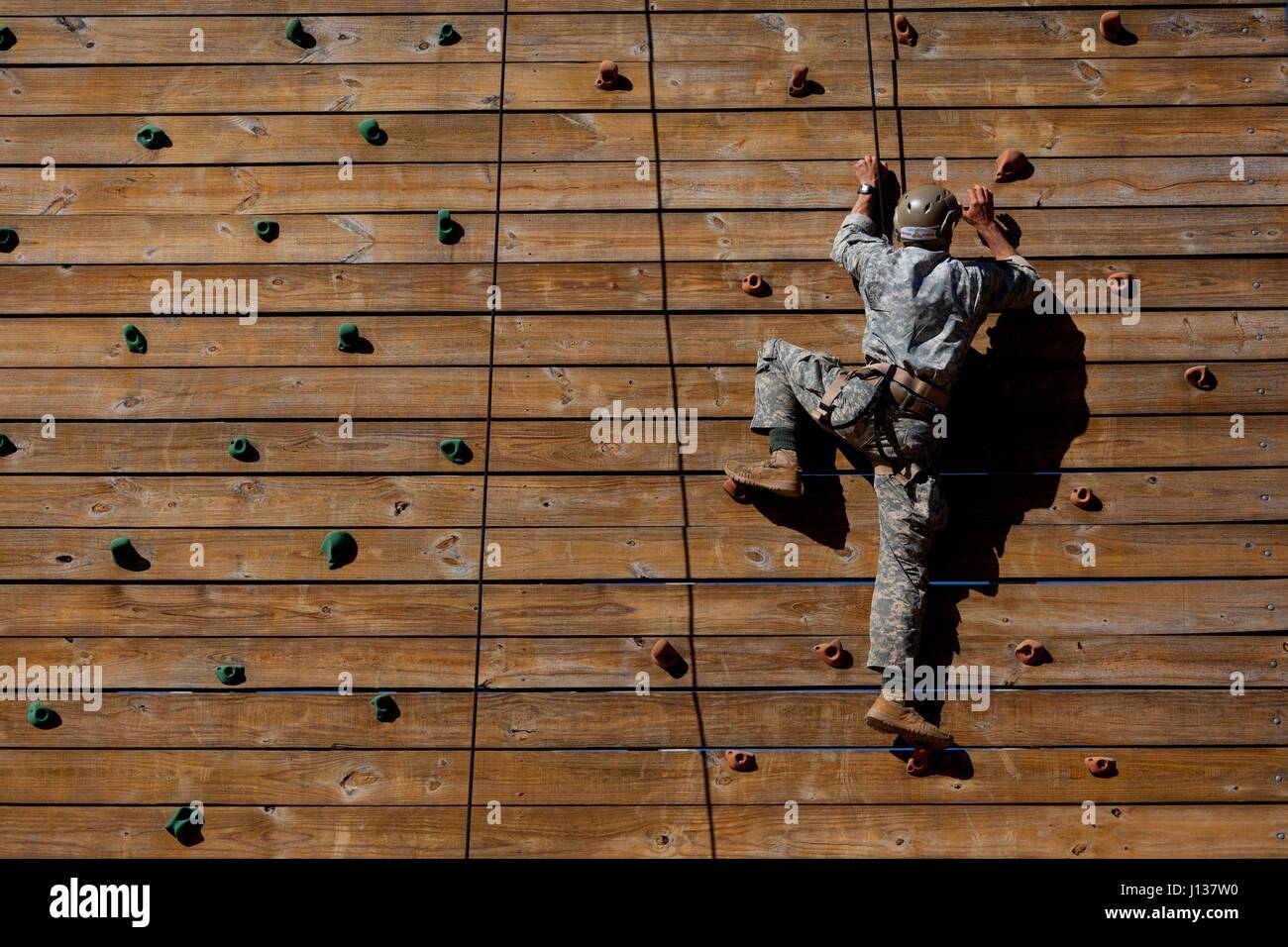 A U.S. Army Ranger performs a wall climb during the Best Ranger ...