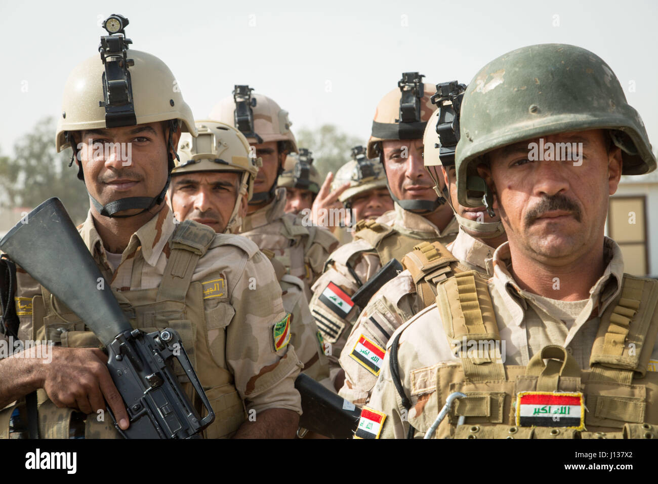 Iraqi security forces soldiers stand in formation before entering a ...