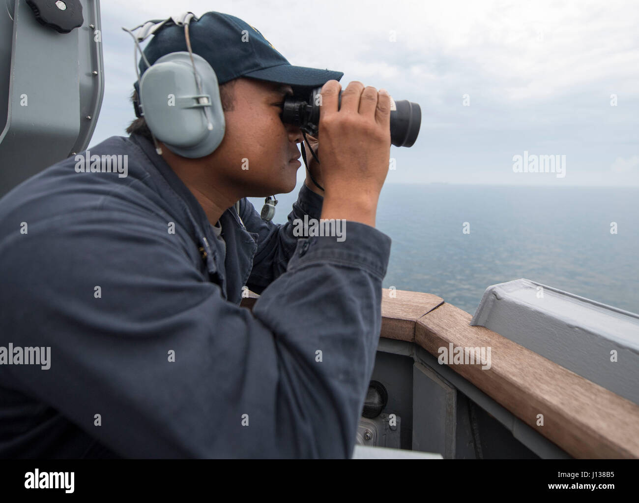 A Boatswain’s Mate stands watch on the bridge of USS Michael Murphy ...