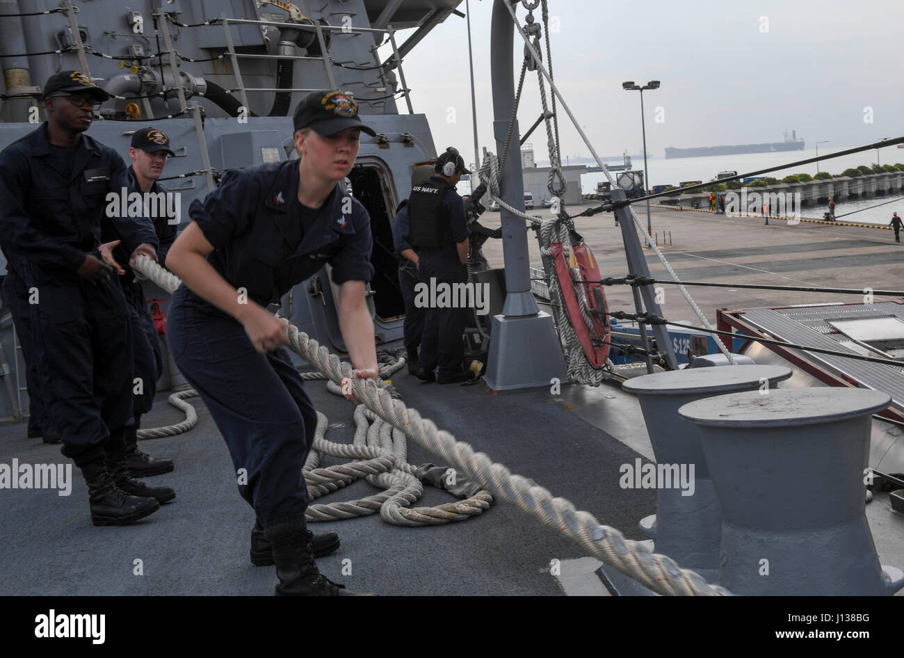 170408-N-RM689-028 SINGAPORE (April 5, 2017) Sailors heave a mooring ...