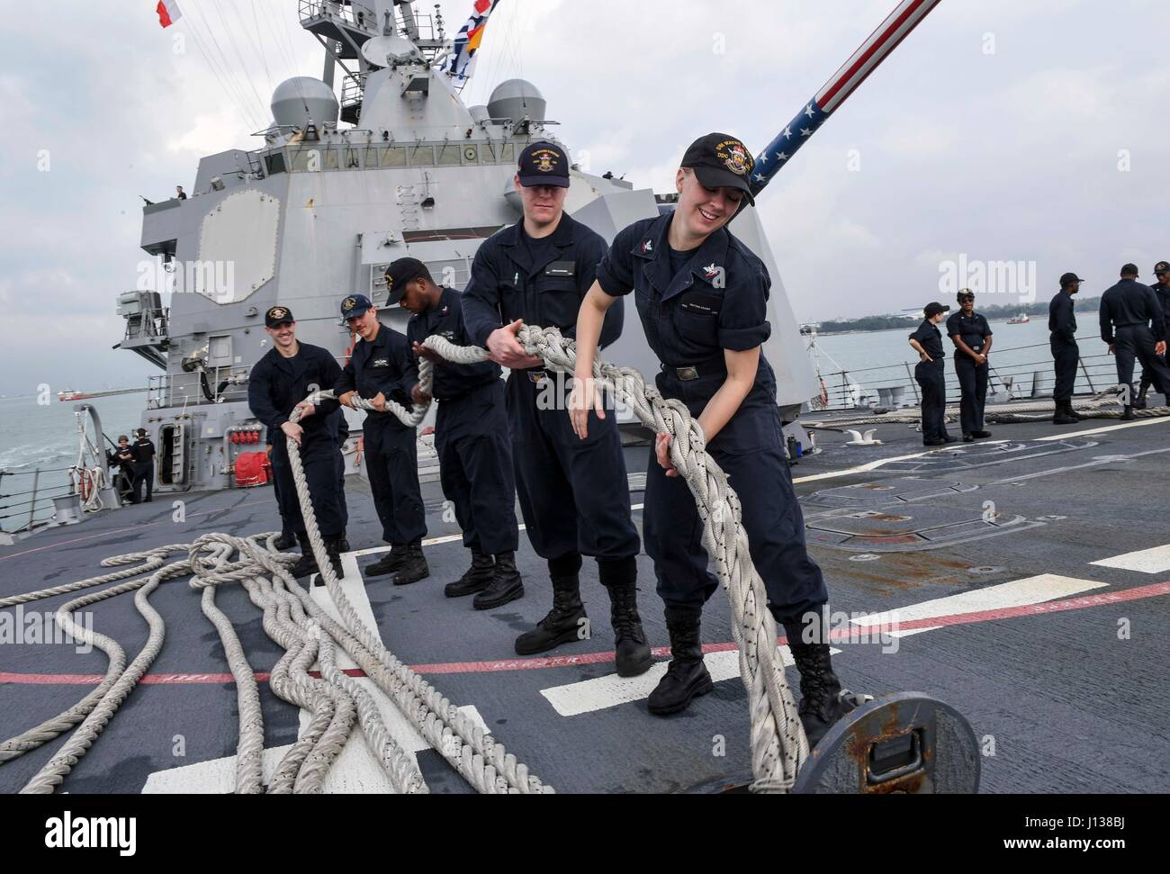 170408-N-RM689-079 SINGAPORE (April 5, 2017) Sailors stow a mooring ...