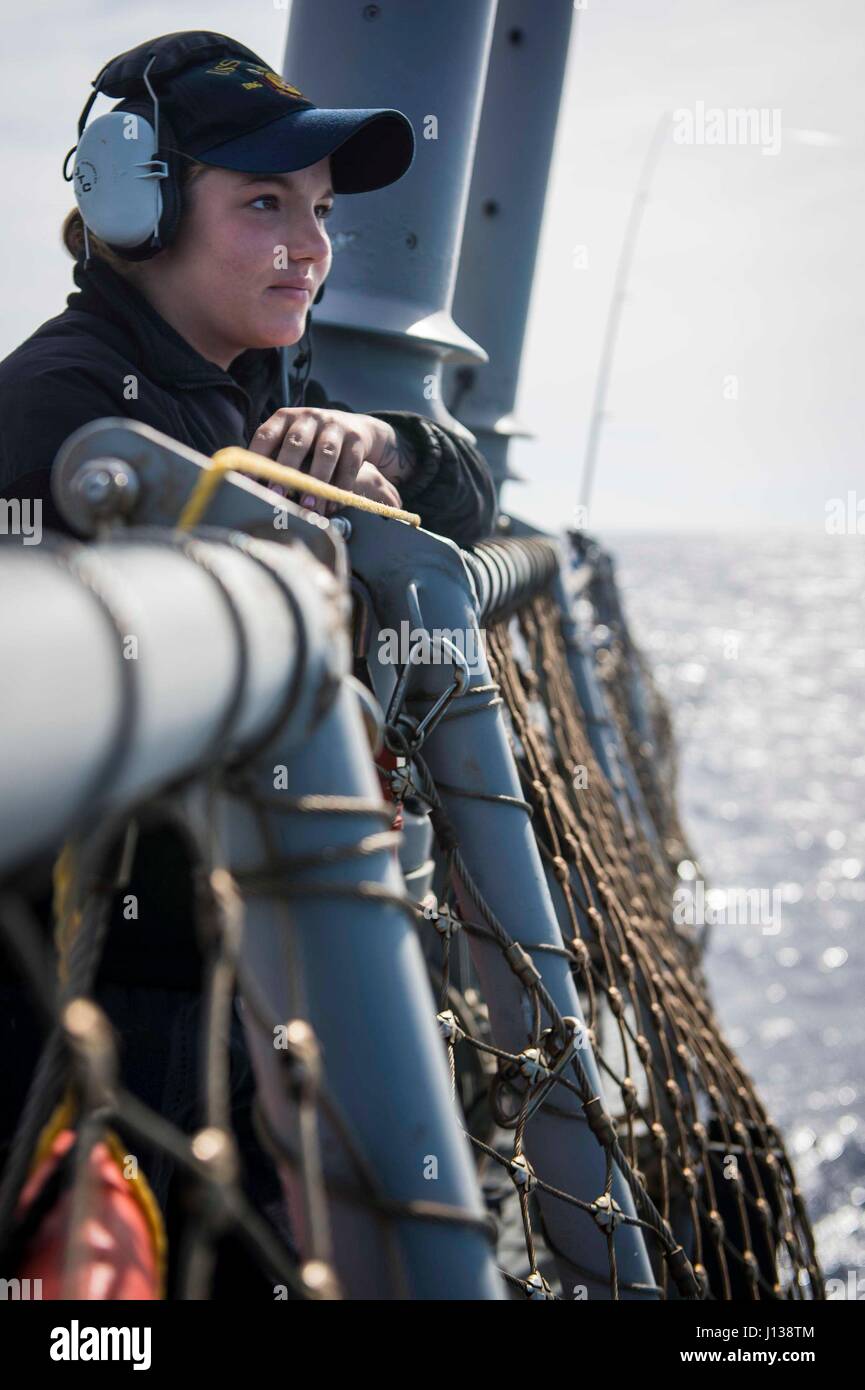 A Boatswain's Mate stands aft lookout aboard USS Ross, an Arleigh Burke ...