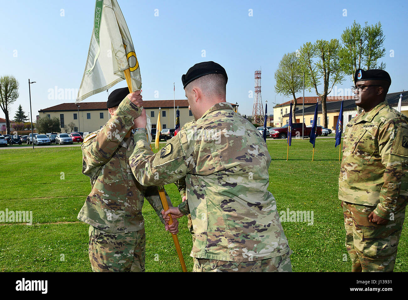 Capt. Timothy Johnson (center), passes the guidon to Maj. Kenneth Kim ...