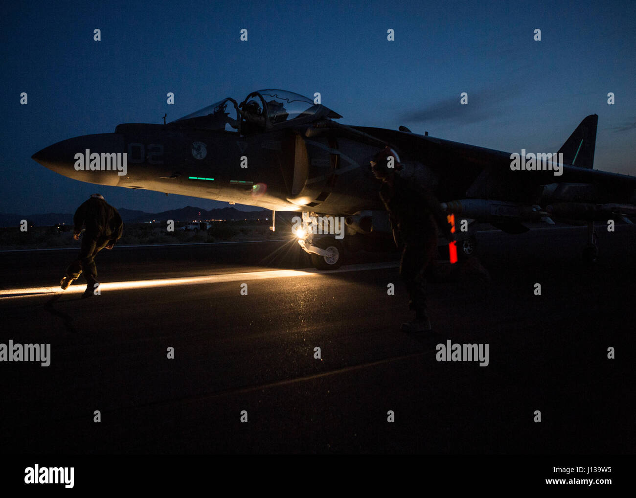 U.S. Marine Corps Lance Cpl. Dwight A. Pence, right, aircraft ordinance ...