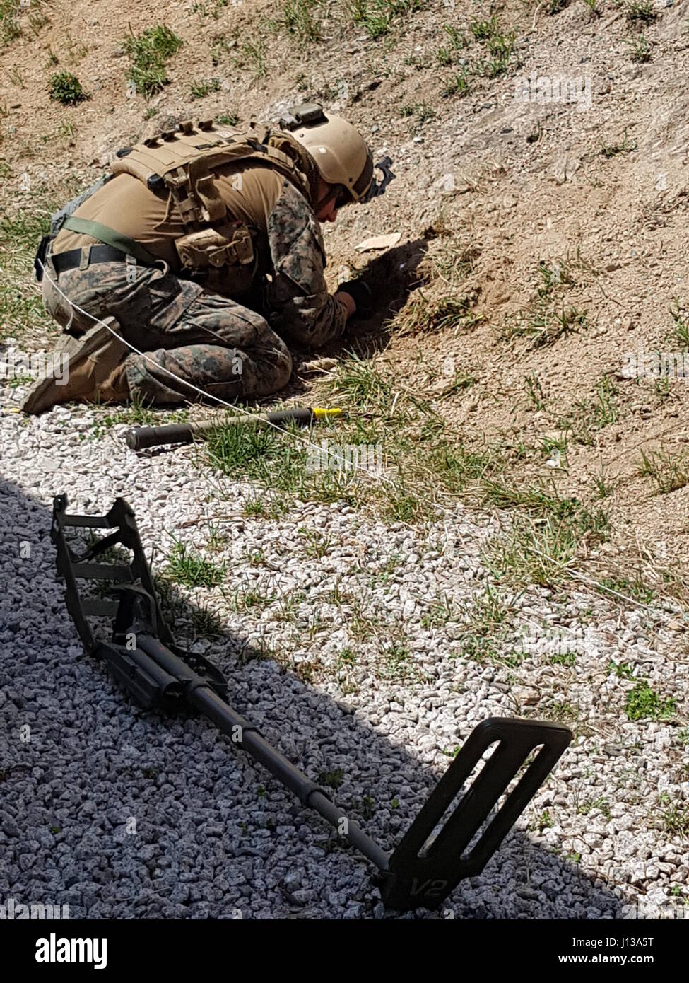 A Marine prepares to disarm a simulated improvised explosive device ...
