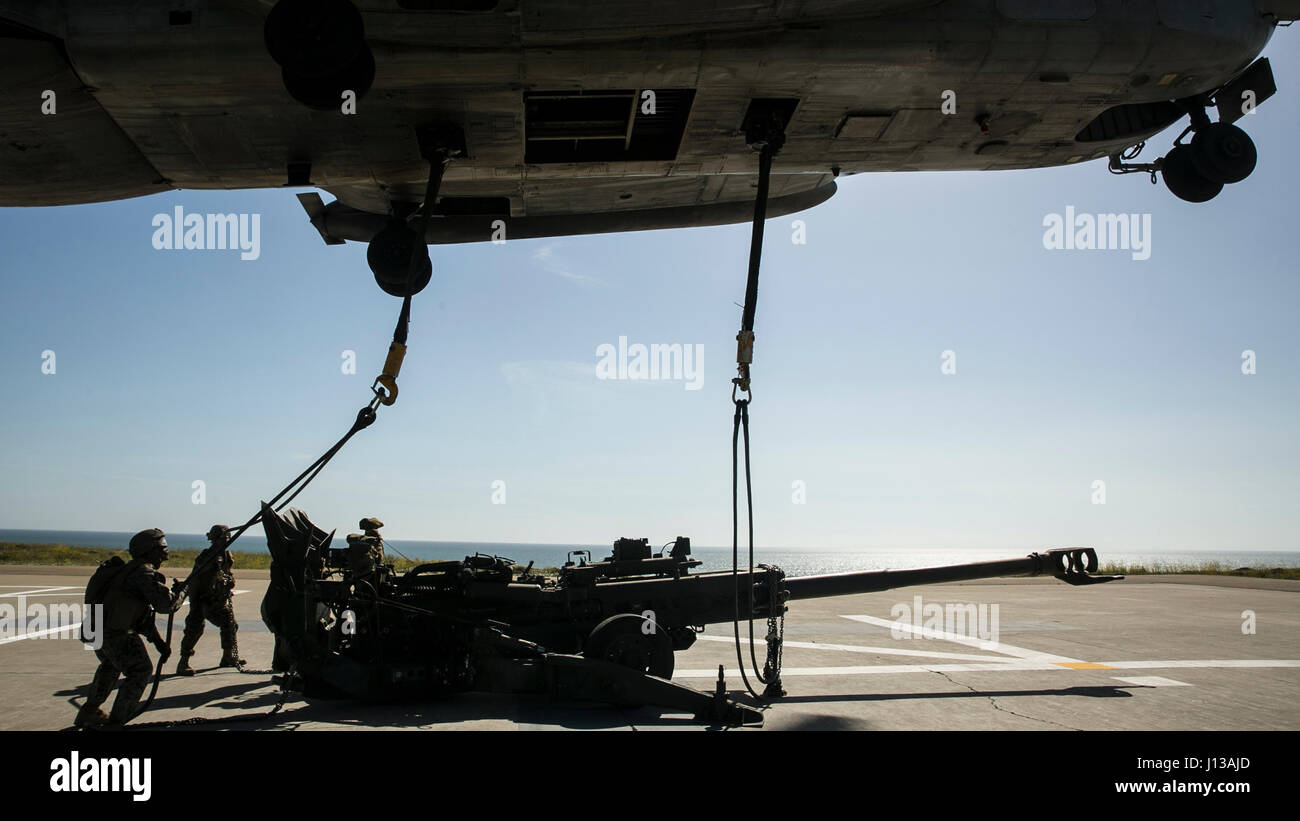 A CH-53E Super Stallion helicopter lifts an M777 howitzer during ...