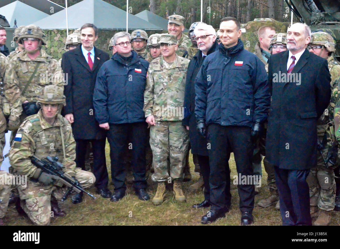 Officials from the U.S. and Poland pose with soldiers of Battle Group ...