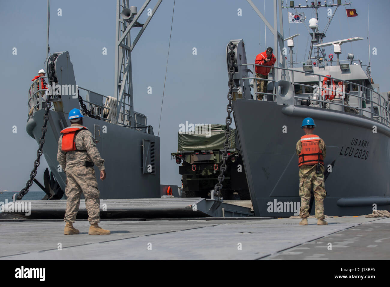 U.S. Marines, Sailors, and Coast Guardsmen aboard the USNS Pililaau ...