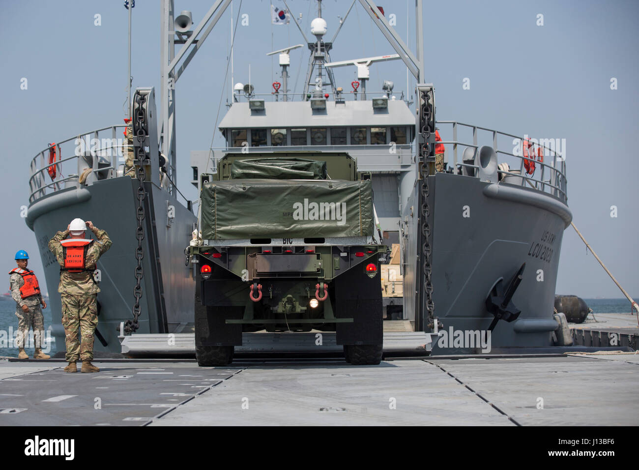 U.S. Marines, Sailors, and Coast Guardsmen aboard the USNS Pililaau ...