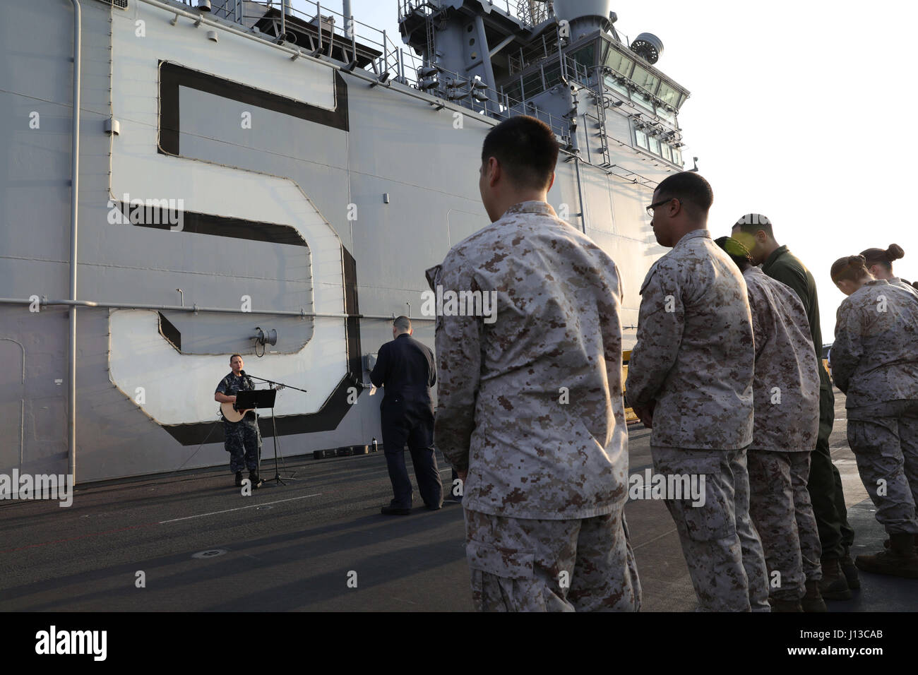 A Seaman participates in an Easter sunrise service aboard USS Bataan ...